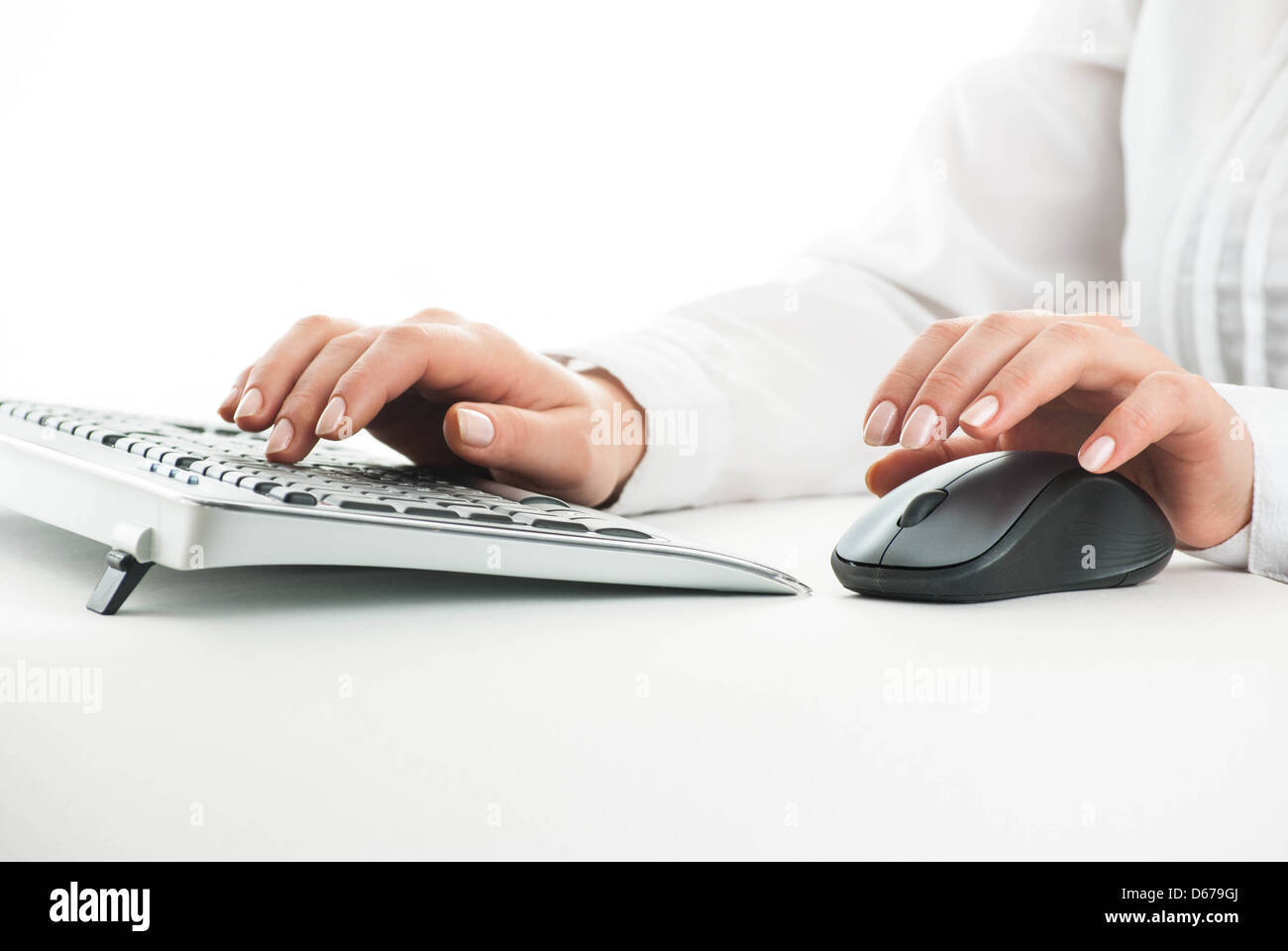 Hands on the black keyboard and on the mouse Stock Photo - Alamy