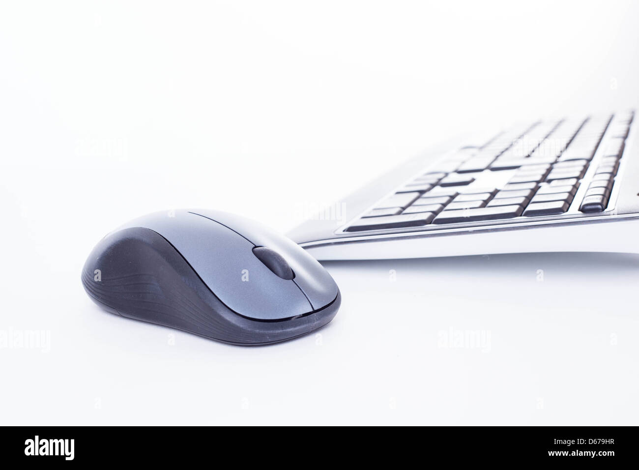 A keyboard and wireless mouse on the white background Stock Photo - Alamy