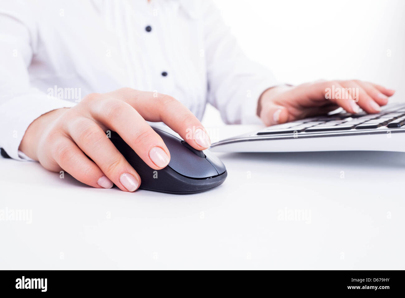 Hands on the black keyboard and on the mouse Stock Photo - Alamy