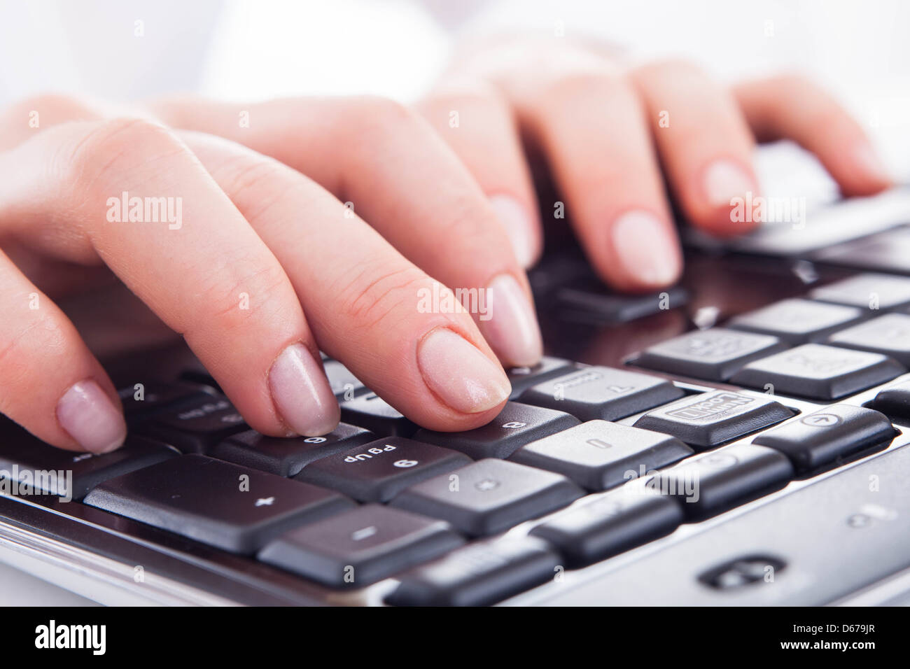 Hands on the black keyboard in the closeup Stock Photo - Alamy