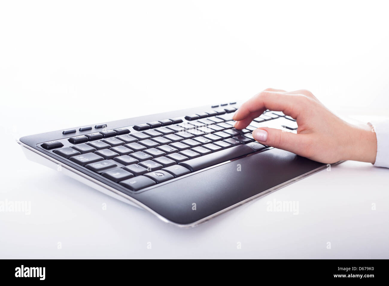 Female hand on the black keyboard on the white Stock Photo - Alamy