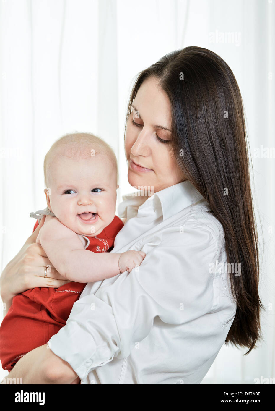 Mother with her happy child on white background Stock Photo - Alamy