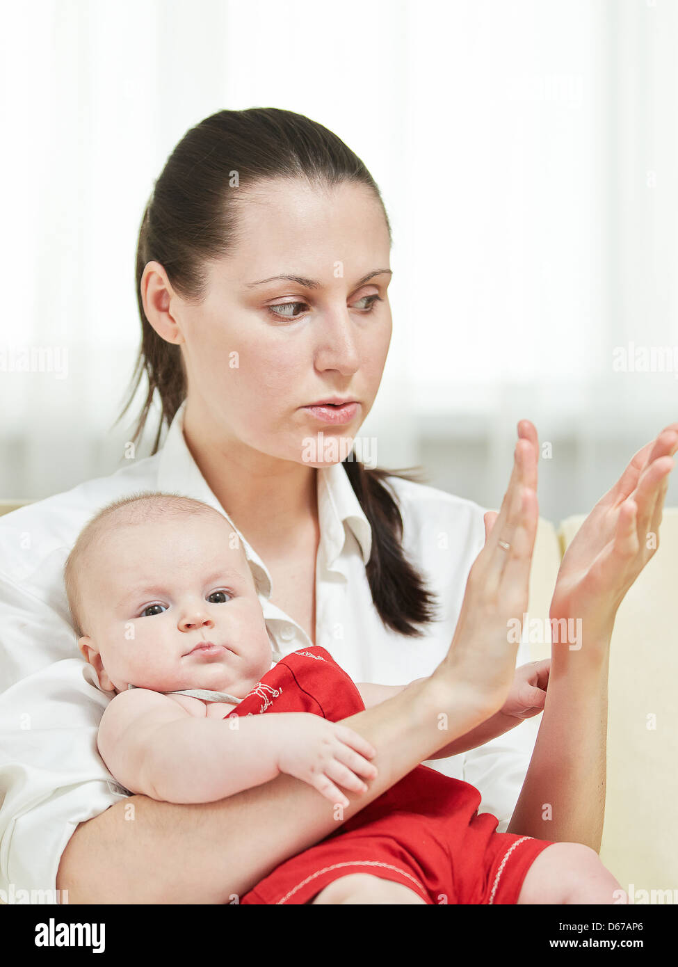 Mother with her child on arms on white background Stock Photo - Alamy