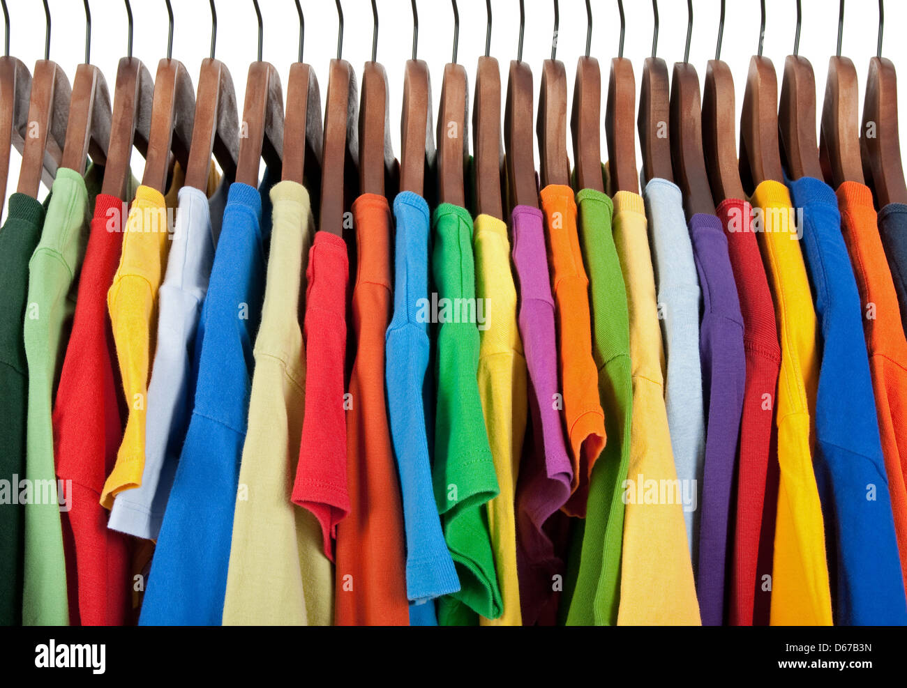 Variety of casual clothes of different colors on wooden hangers Stock ...