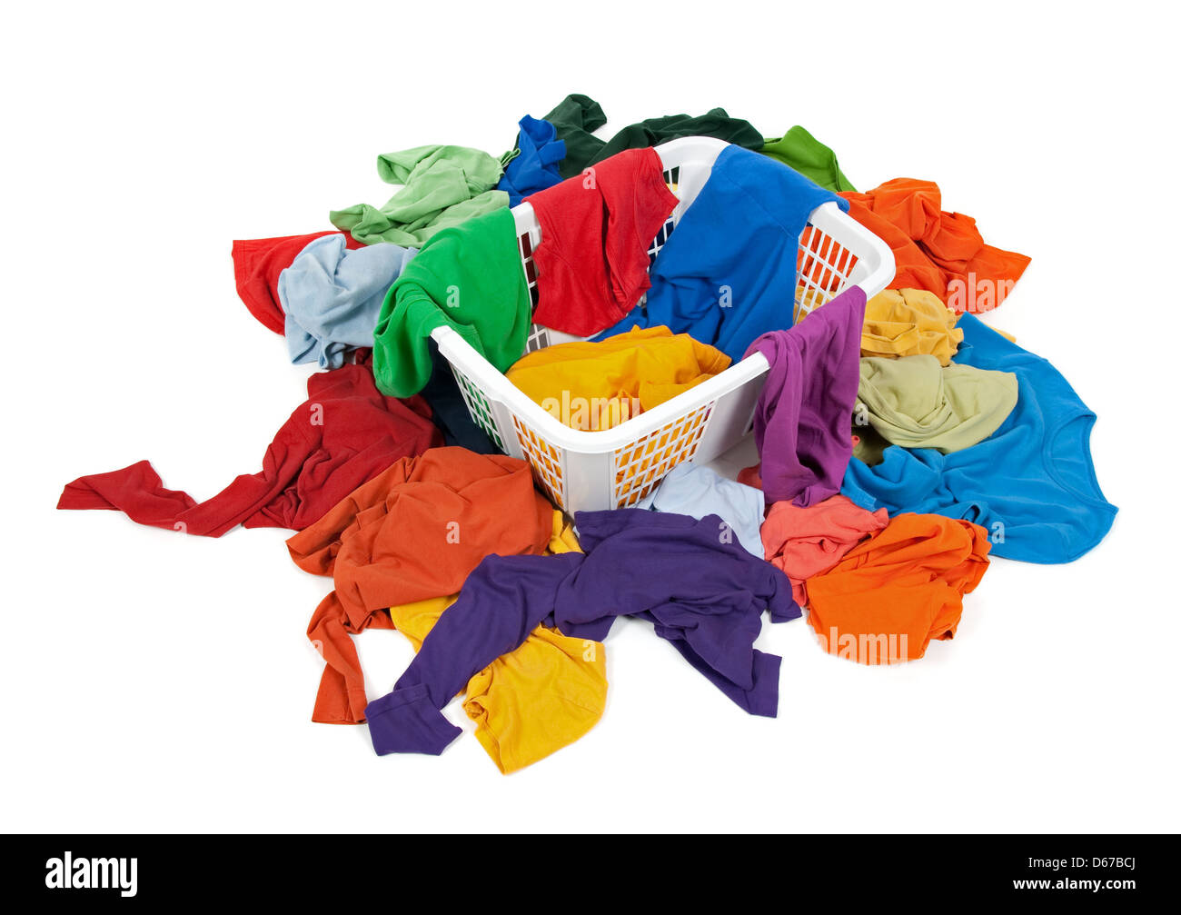 Bright messy clothes in a laundry basket and around it. Isolated on ...