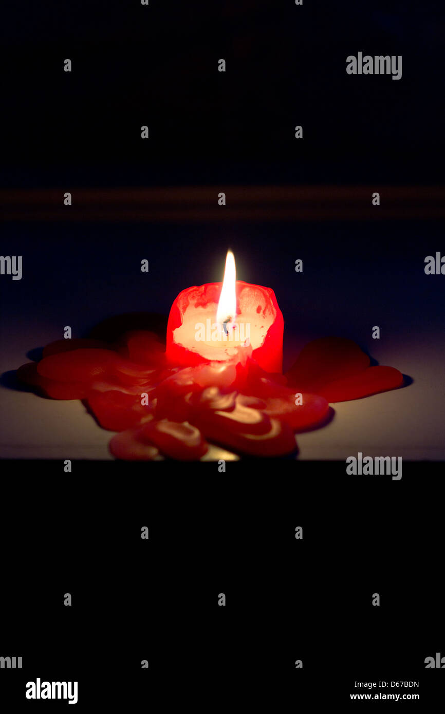 Red candle. Wax melting on the table Stock Photo - Alamy