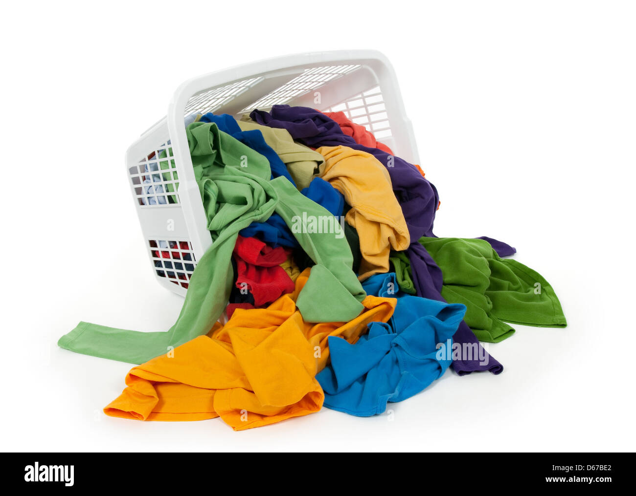 Bright colorful clothes falling out of a laundry basket. Isolated on ...