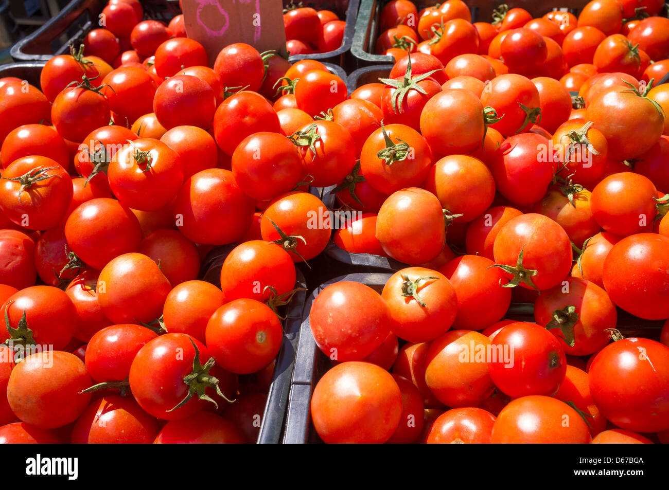 A heap of ripe tomatoes at a market stall in a full frame take Stock ...