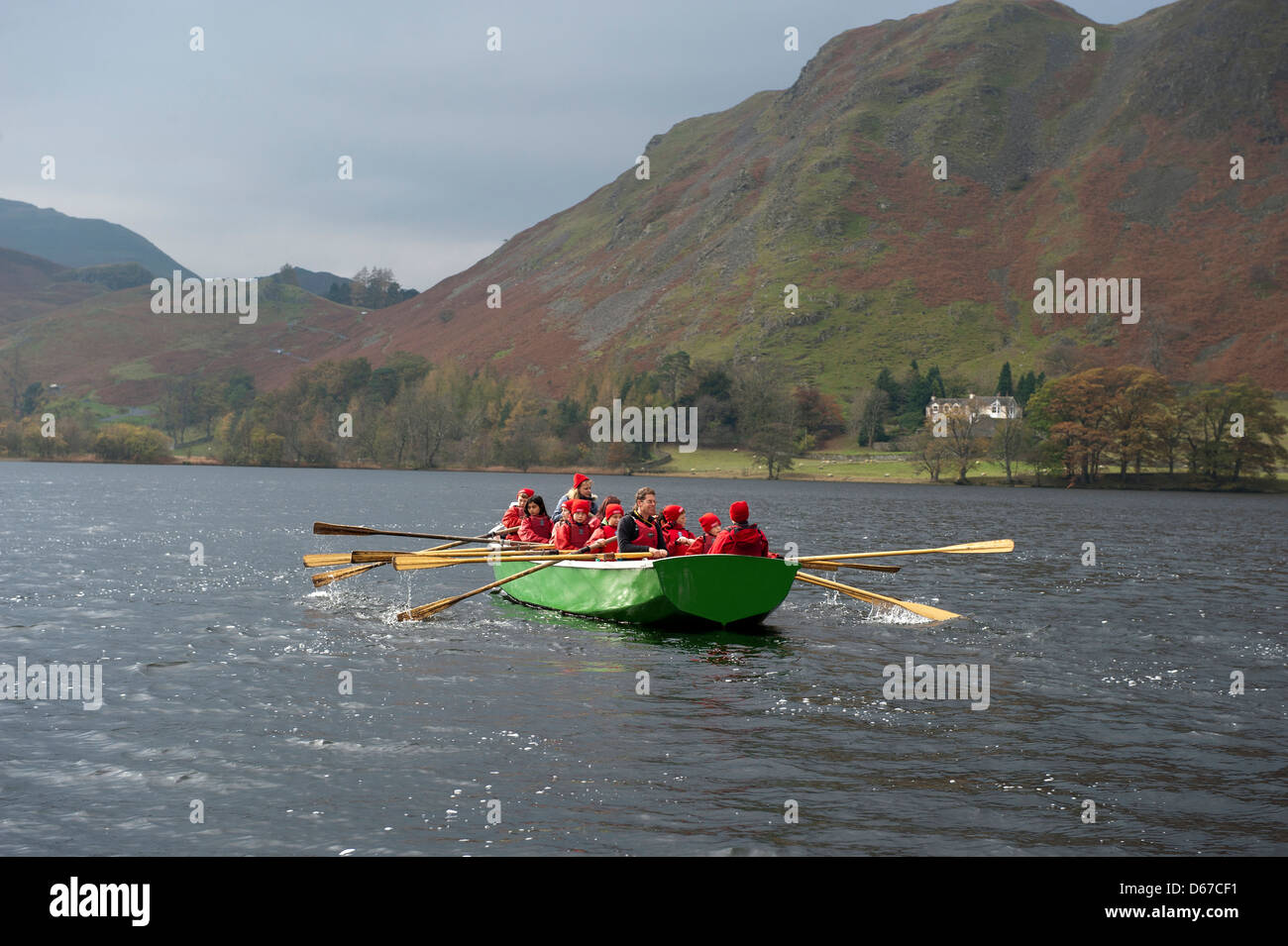 Young school children rowing a boat on Ullswater in the English Lake ...