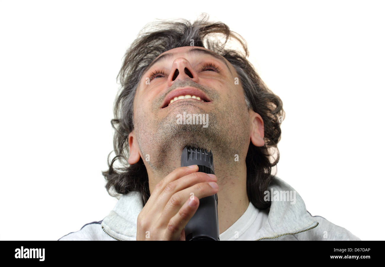 Happy man using electric shaver Stock Photo - Alamy