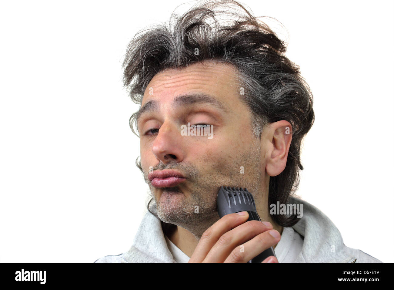 Man shaving his cheek using electric shaver Stock Photo - Alamy