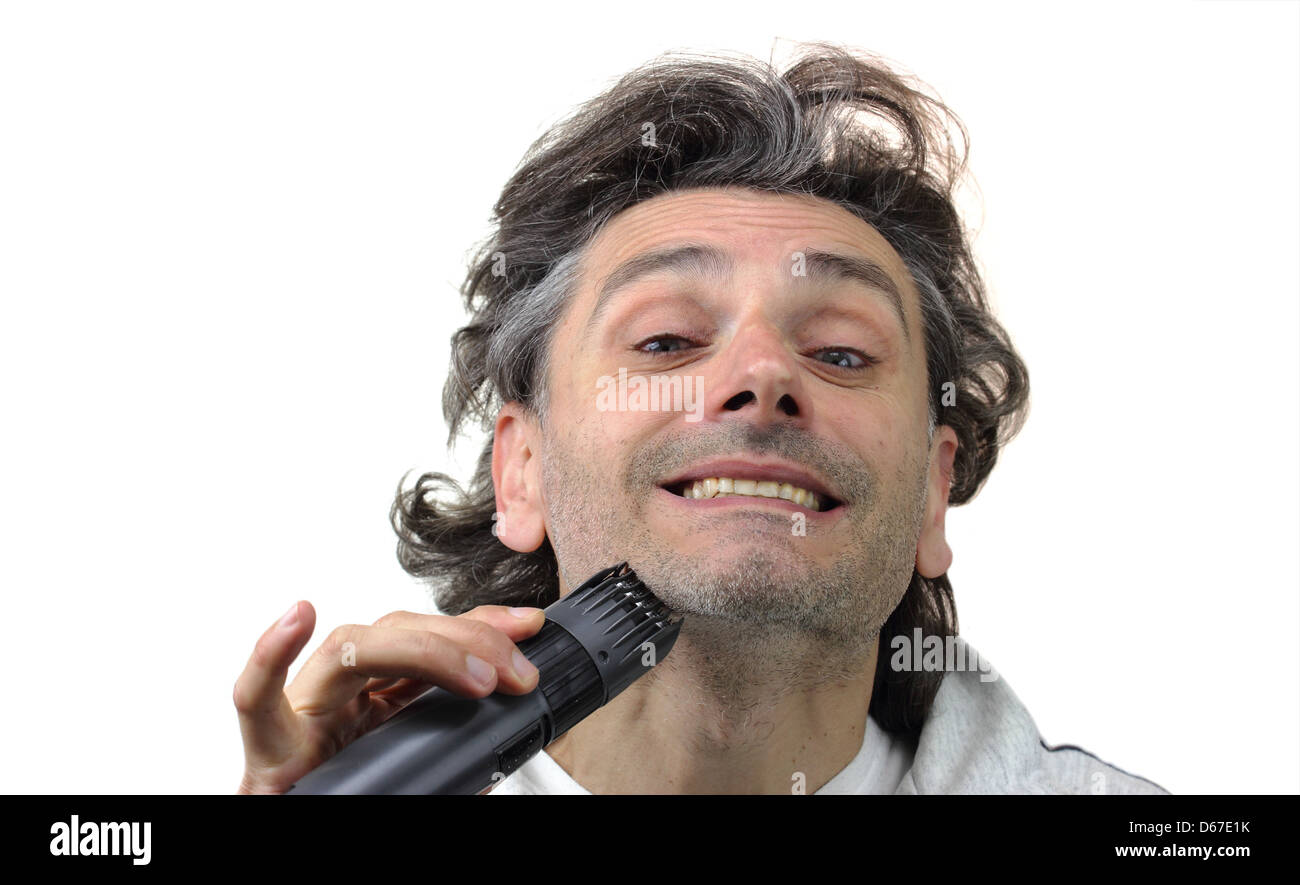 Man shaving his cheek using electric shaver Stock Photo - Alamy
