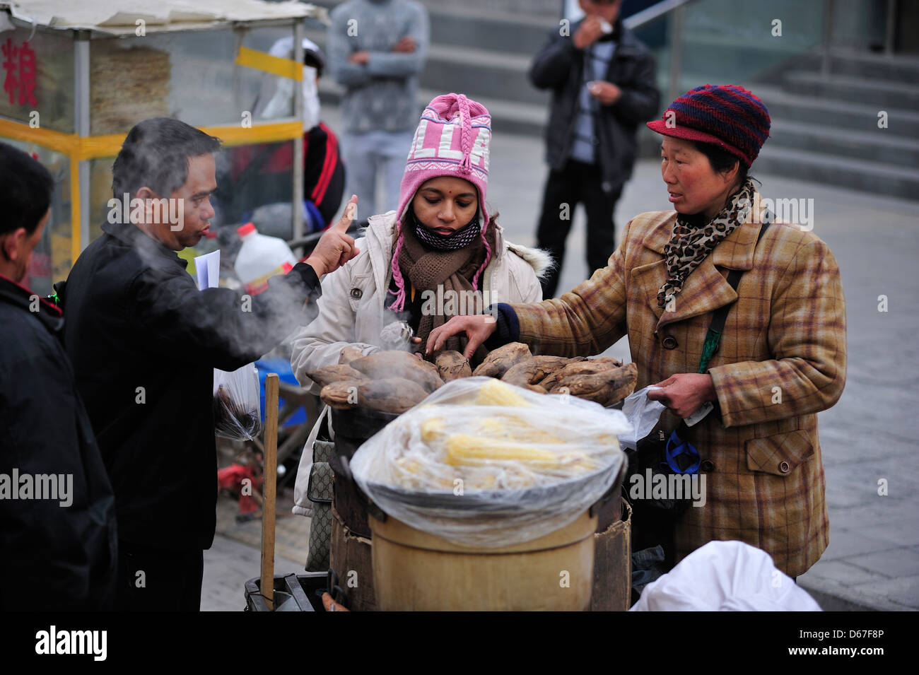 Beijing, China - April 4: A local Chinese hawker sells foods to the ...
