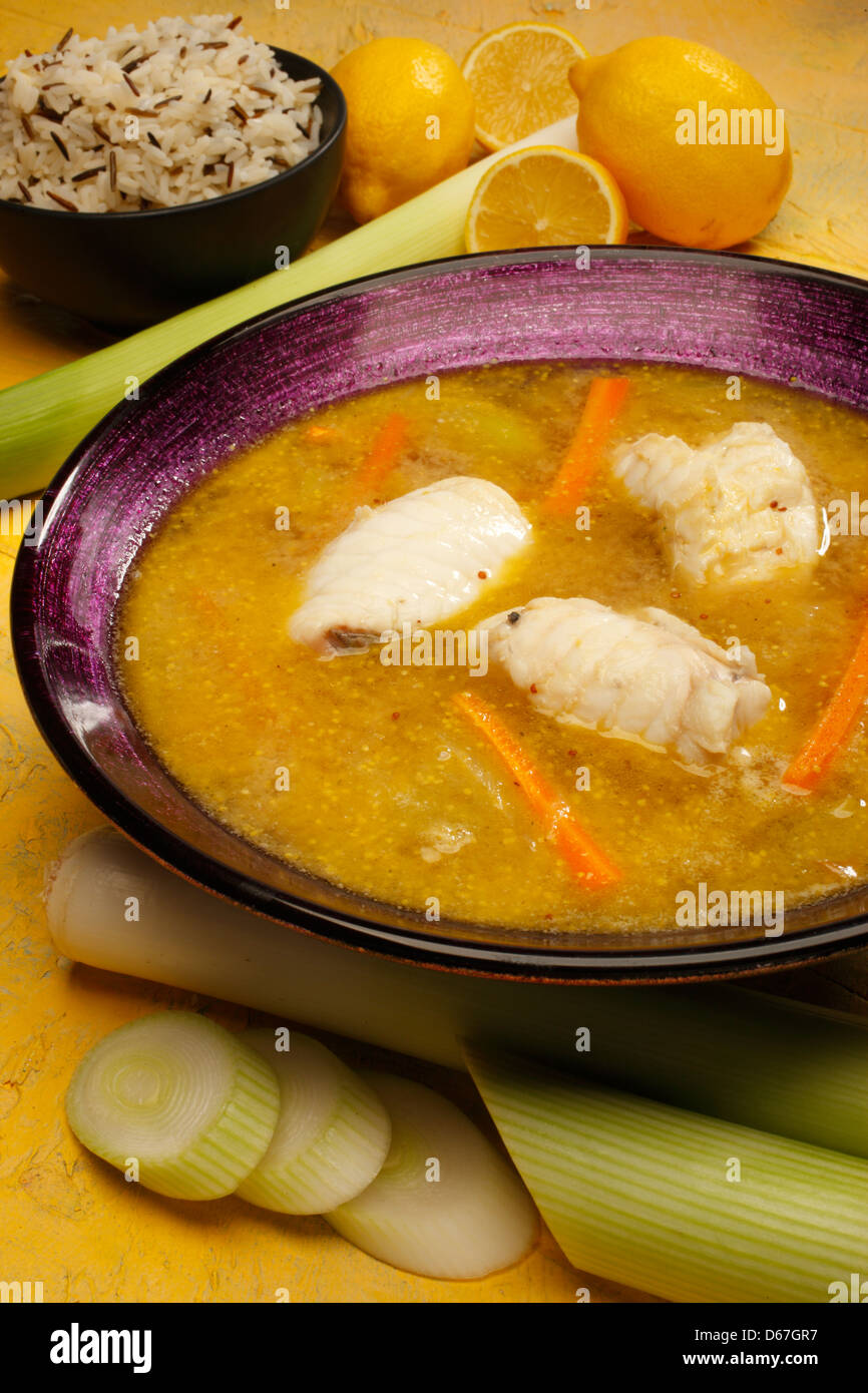 Asian Monkfish with wild rice in separate bowls with chopped leeks and ...