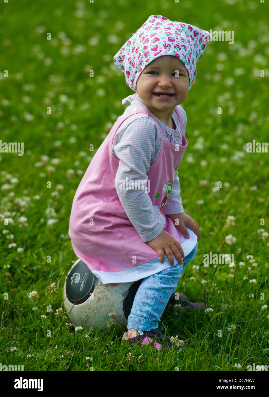 Two-year-old Anna Marie sits on a soccer ball in Pillgram, Germany, 17 ...