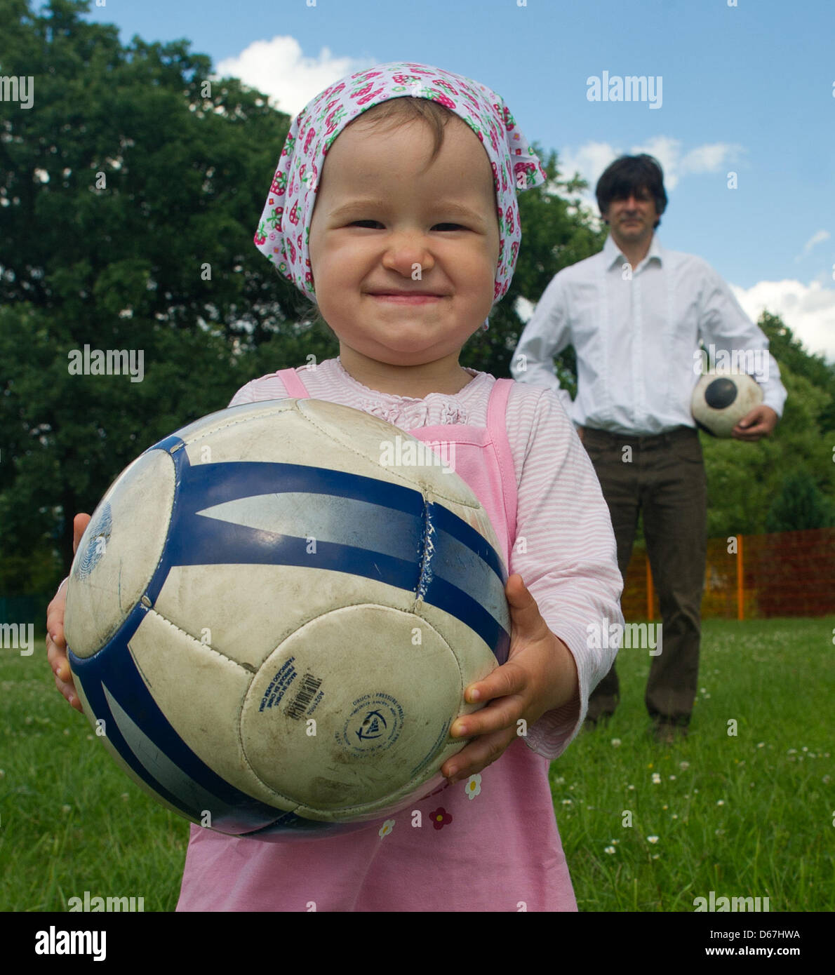 Two-year-old Anna Marie proudly presents her soccer ball in Pillgram ...