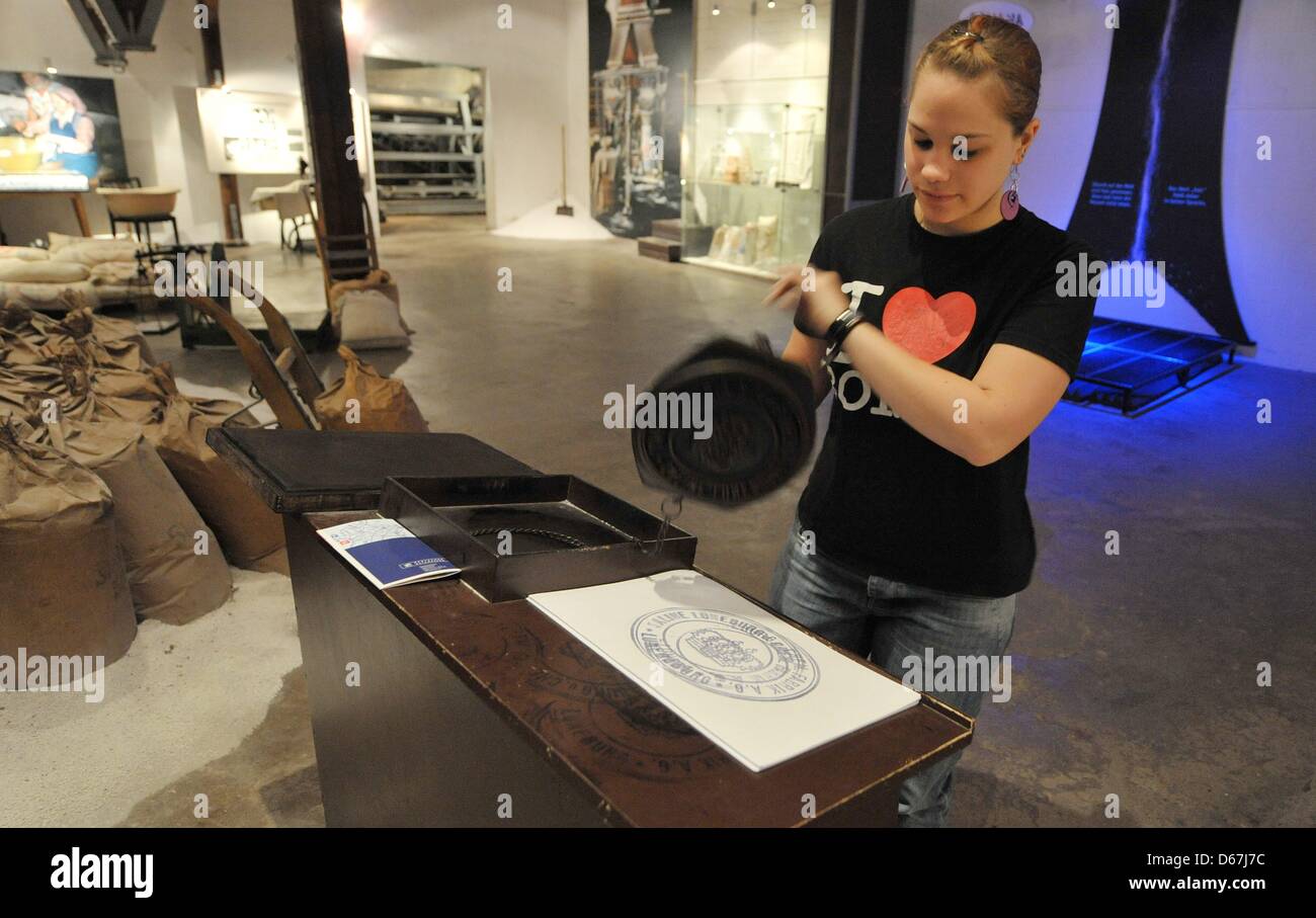 Henrike Urbaum tries out a big stamp which was used to mark salt bags ...