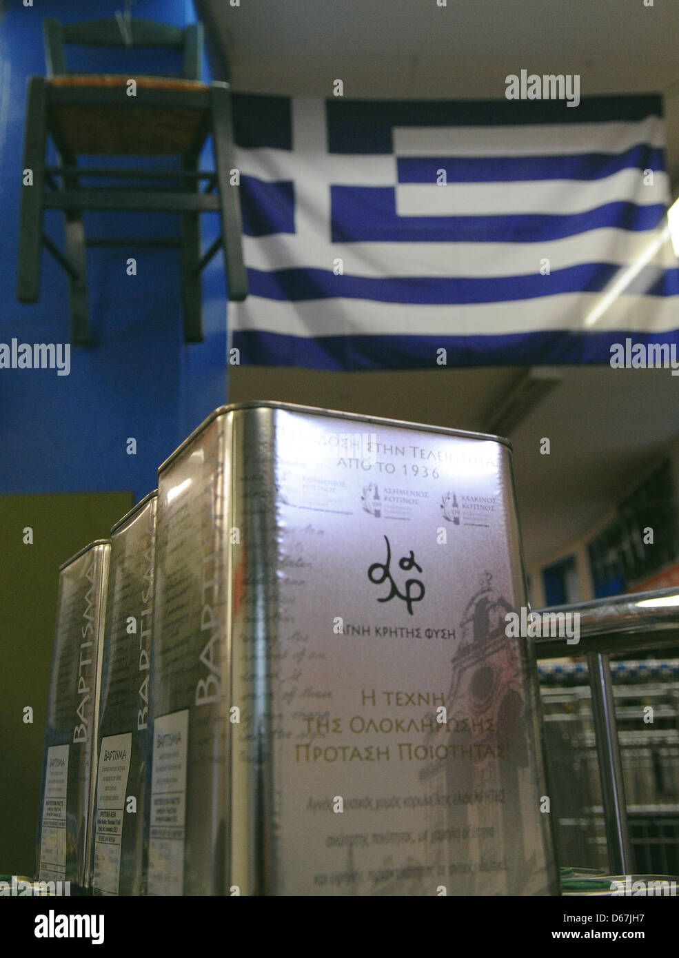 A Greek flag is pictured with Greek olive oil at a Greek grocery store ...