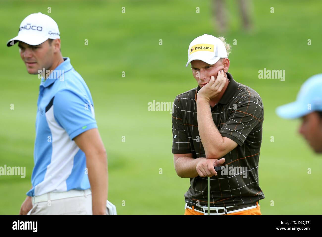 German golfer Marcel Siem (R) grabs his face next to golfer Martin ...