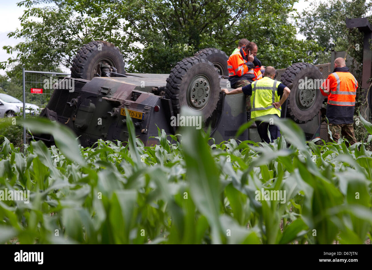 A light wheeled tank of the Dutch Army lies on the embankment of the A1 ...