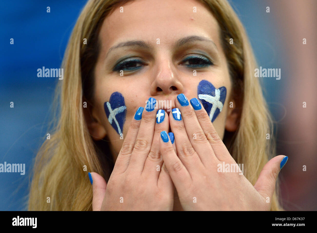 A female Greek supporter celebrates on the stand prior to the UEFA EURO ...