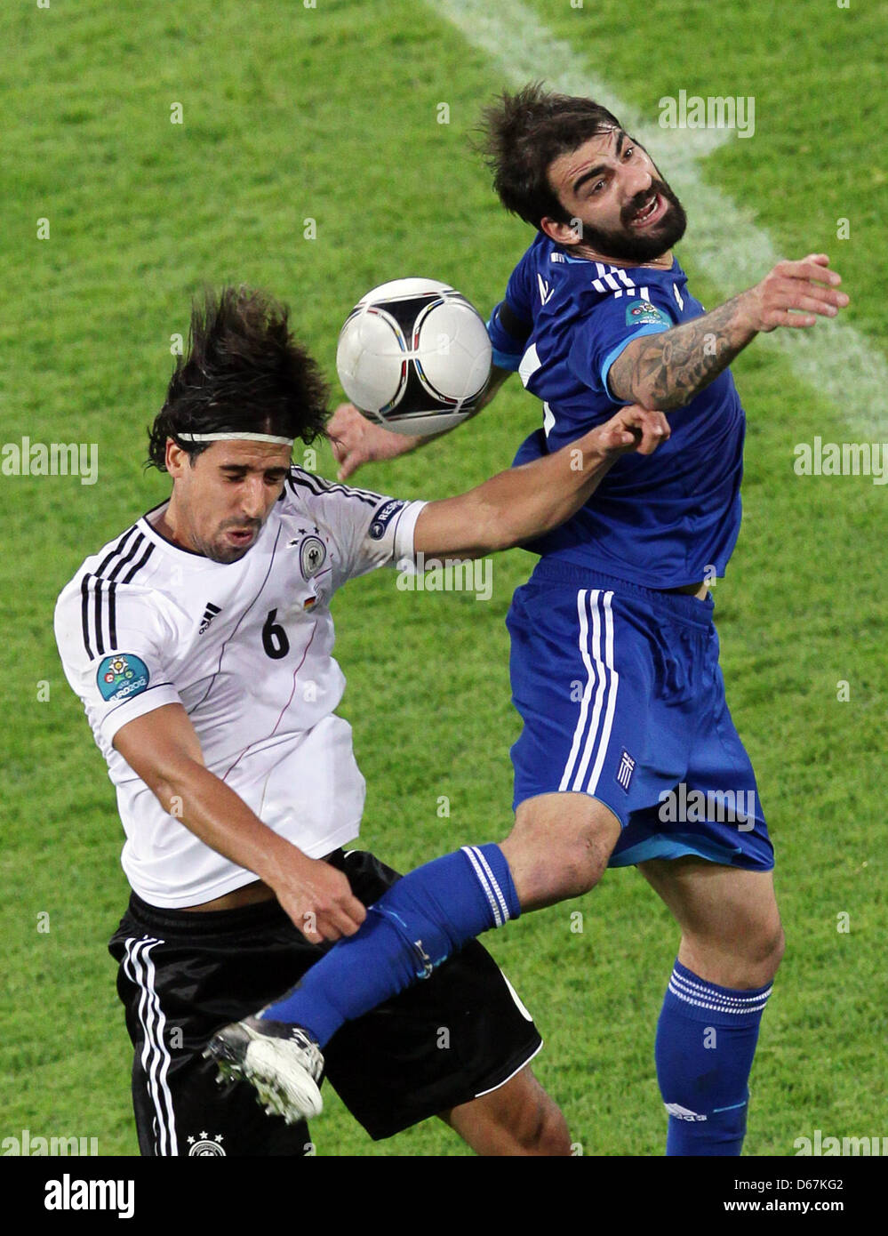 Germany's Sami Khedira (L) and Greece's Grigoris Makos vie for the ball ...