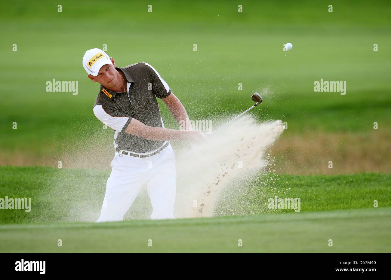 German golfer Marcel Siem hits the ball out of the bunker during the ...