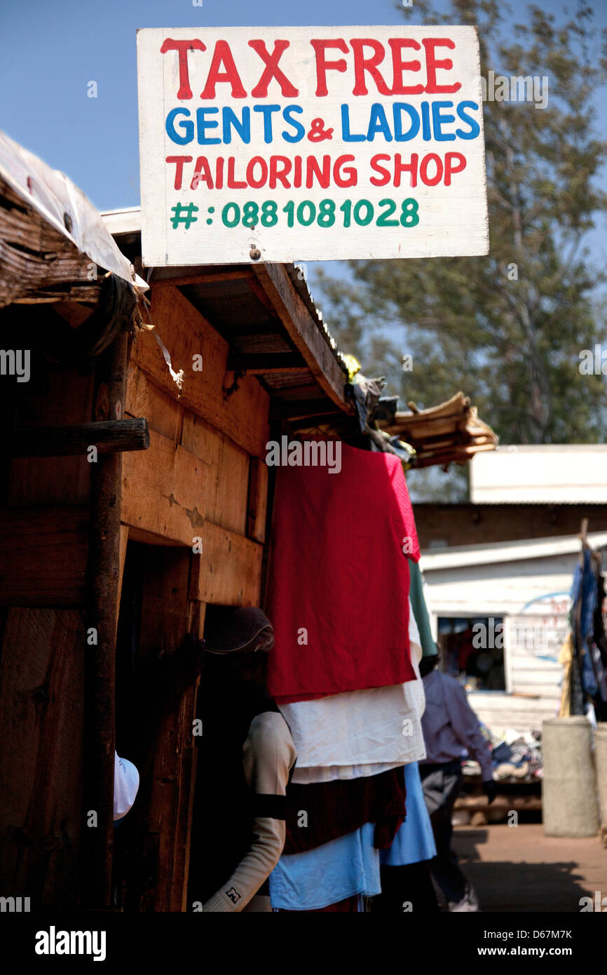 Tailor shop hangs over shack door Stock Photo - Alamy