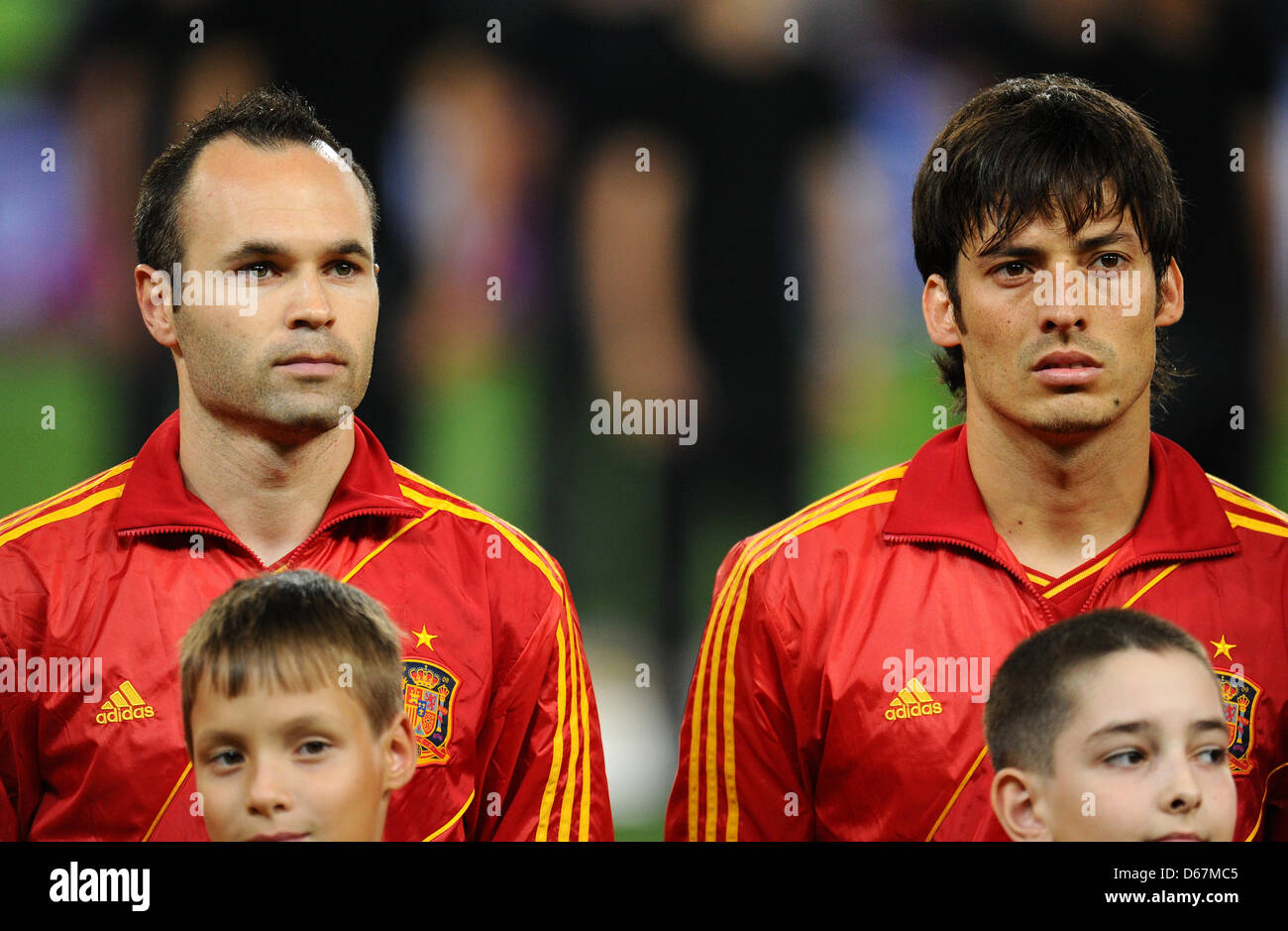 Spain's Andres Iniesta (l) and David Silva listen to the national ...