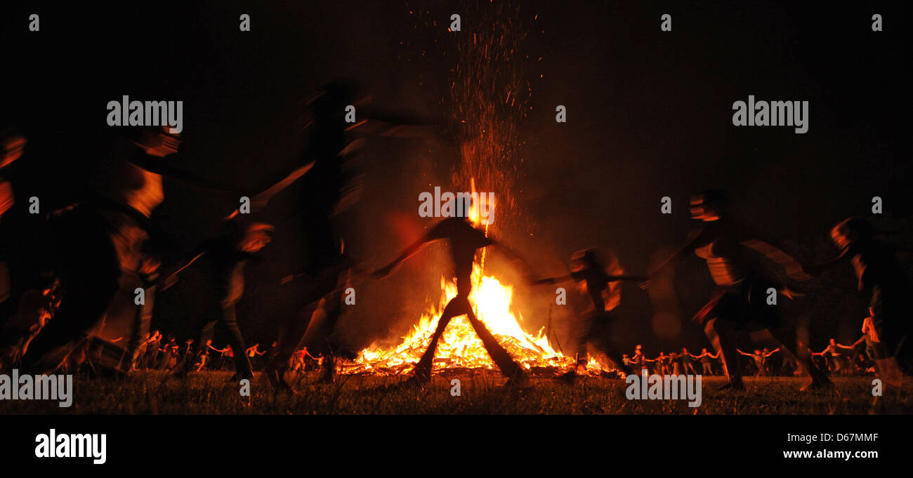 Visitors dance around a midsummer fire in Freiburg, Germany, 23 June ...
