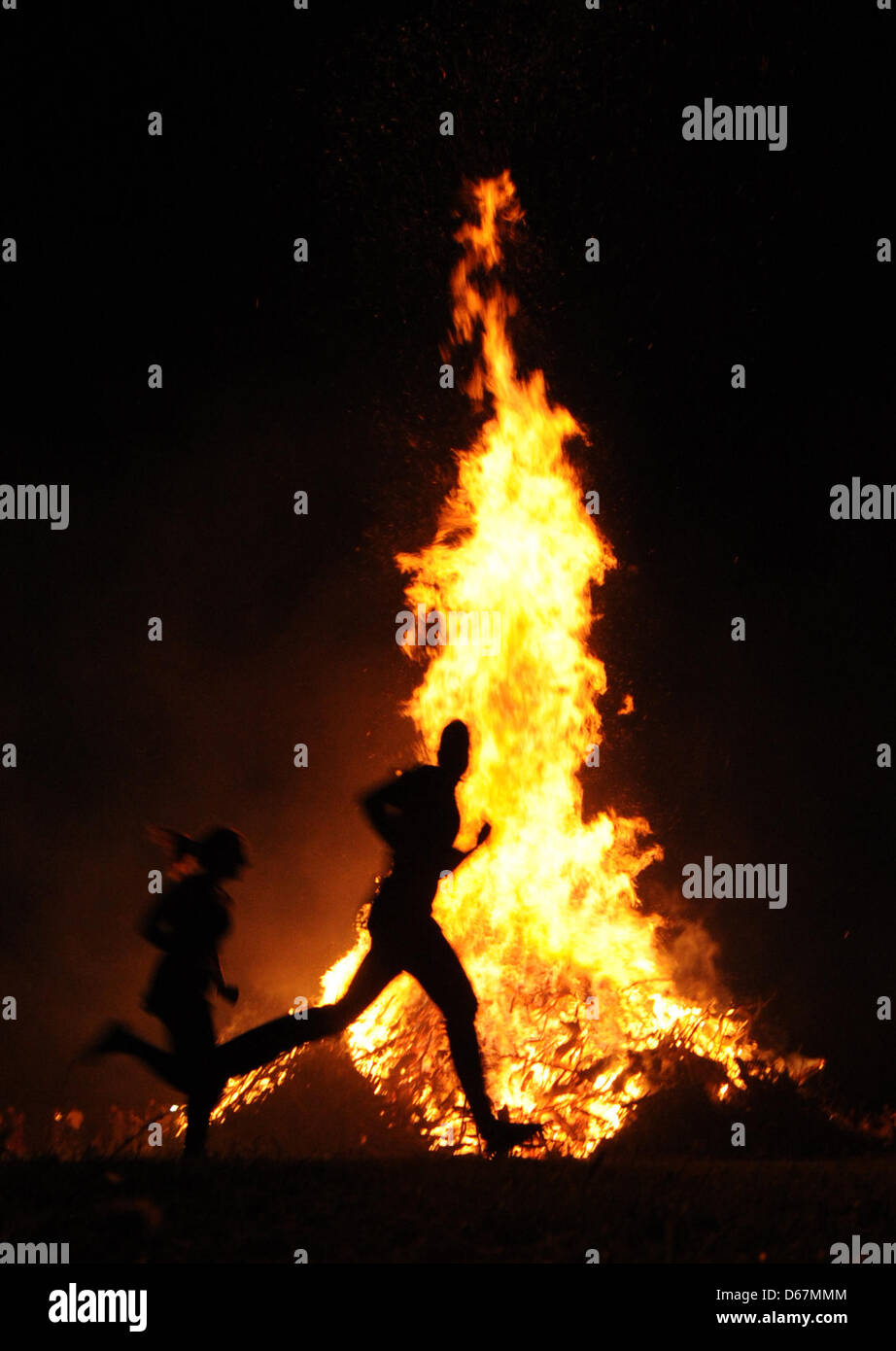 People dance around a midsummer fire in Freiburg, Germany, 23 June 2012 ...