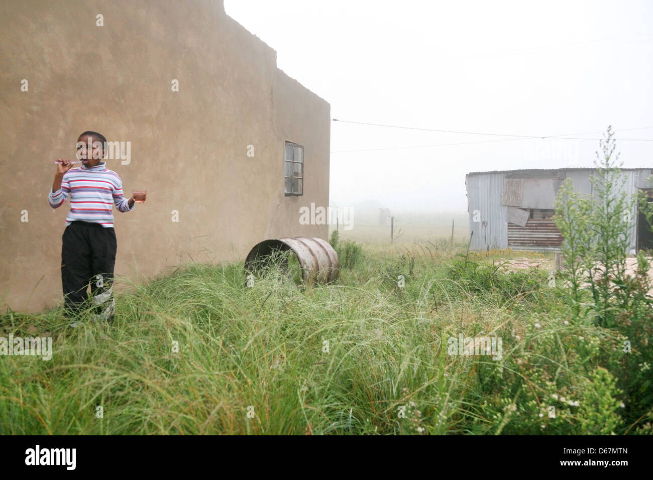 African child brushing teeth outside her home Stock Photo - Alamy
