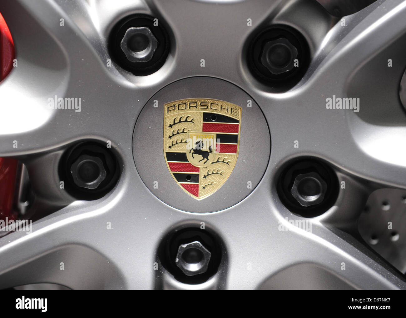 The logo of Porsche is visible on a rim of a wheel at the general ...
