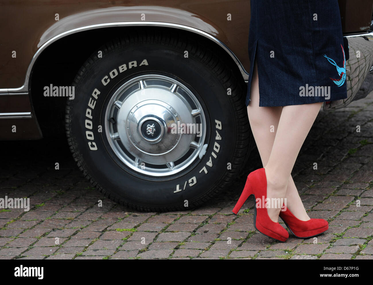 At a photocall for the 2nd annual US Car Convention, models pose with ...