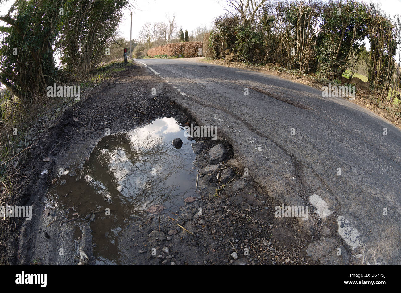 Potholes in country road caused by snow and freezing weather melting ...