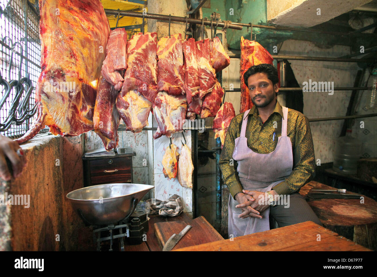 A butcher stands in his store in Bangalore, India, 22 June 2012. Photo ...