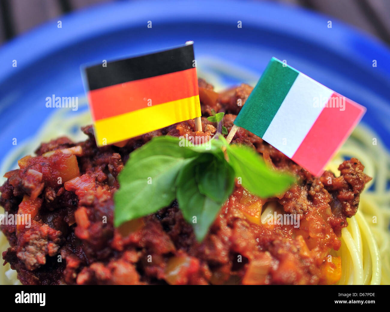 A plate of spaghetti has been decorated with a German and Italian flag ...