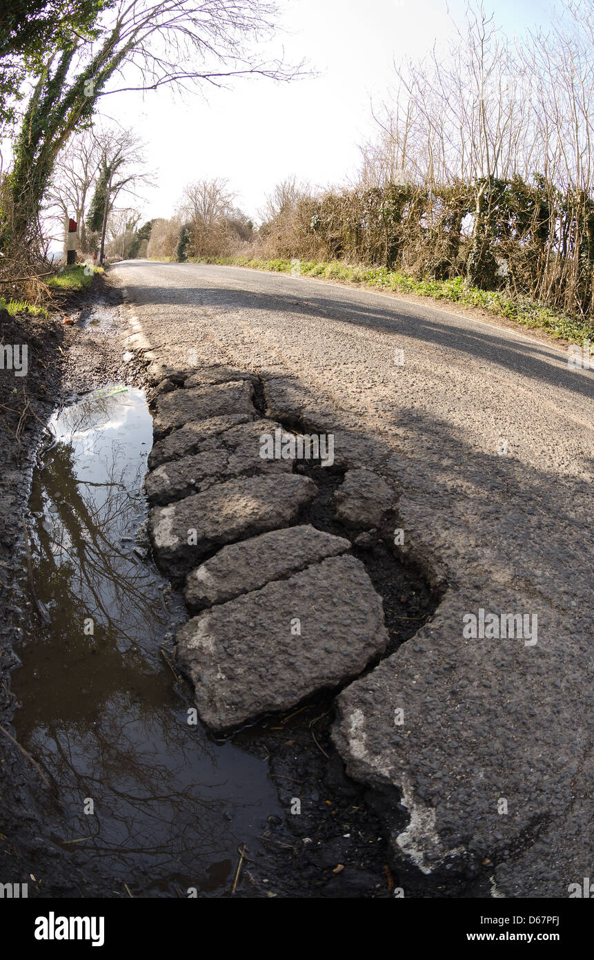 Potholes in country road caused by snow and freezing weather melting ...
