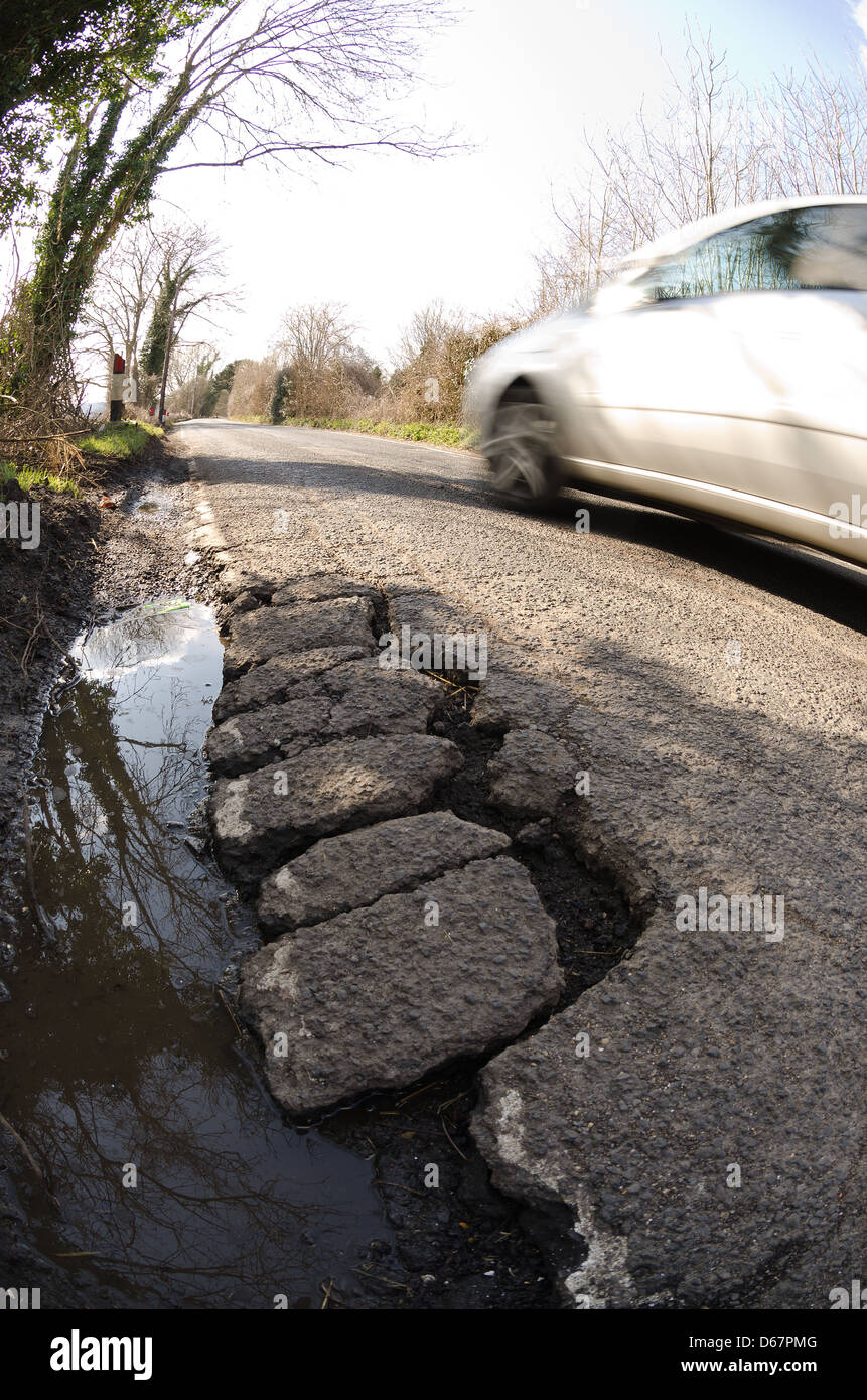 Potholes in country road caused by snow and freezing weather melting ...