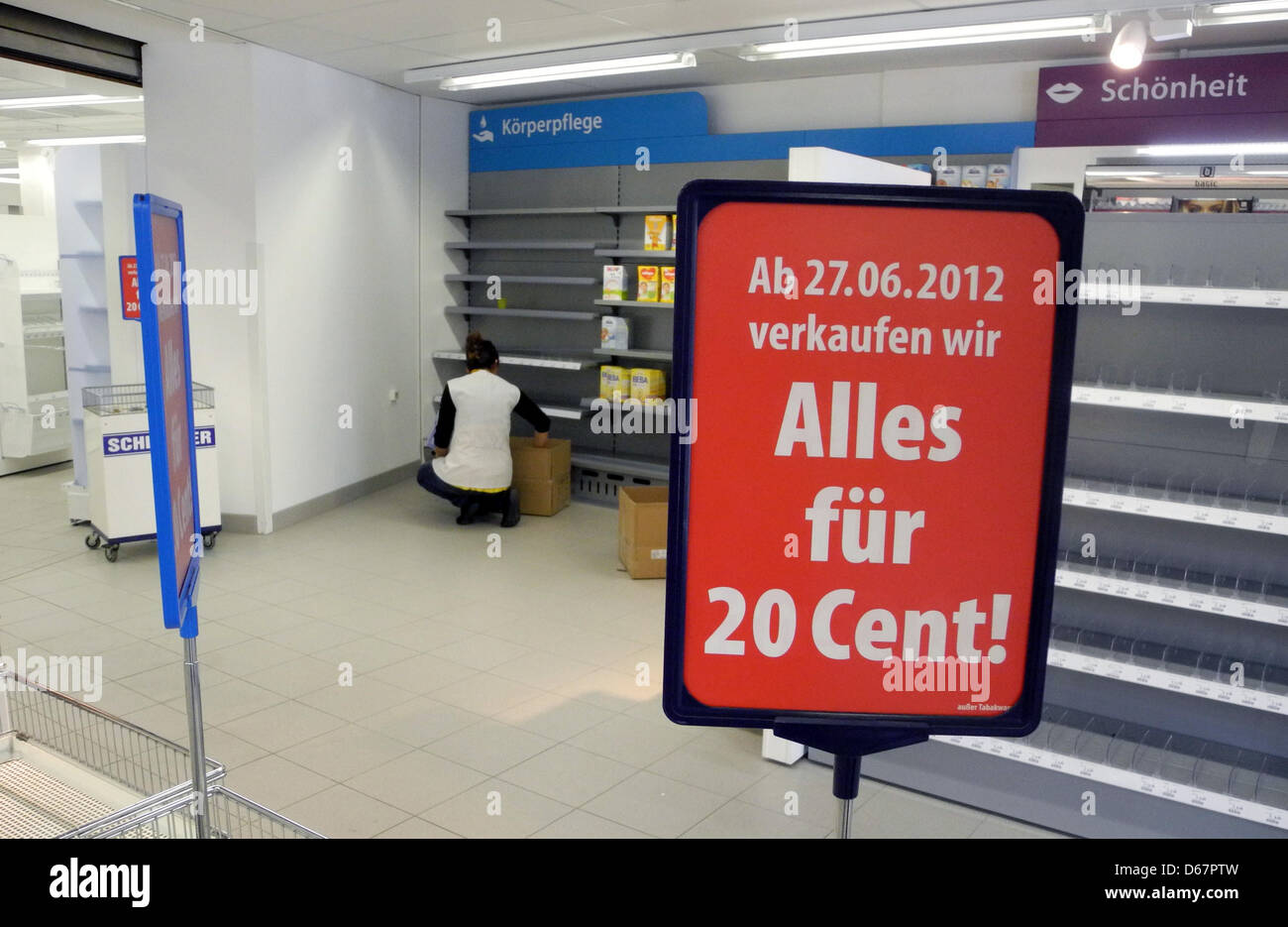 An empoyee of insolvent drugstore chain Schlecker empties shelves in a ...