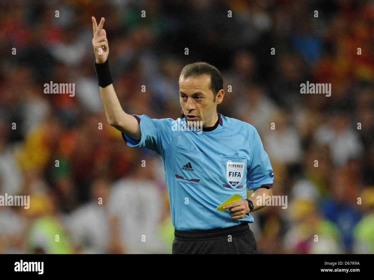 Turkish referee Cuneyt Cakir gestures during UEFA EURO 2012 semi-final ...