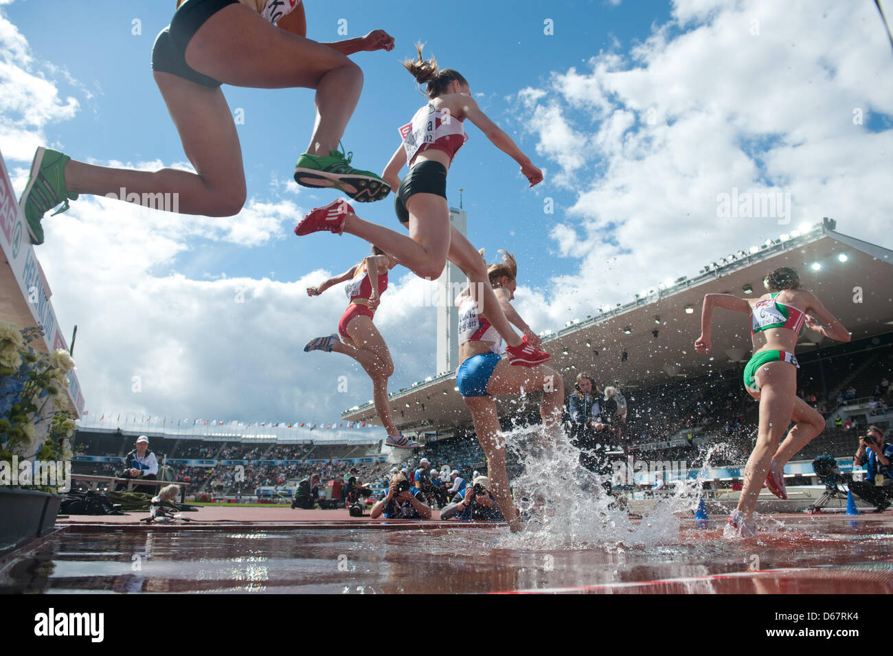 Competitor Pass The Water Jump In The 3000m Steeplechase Semifinal Of