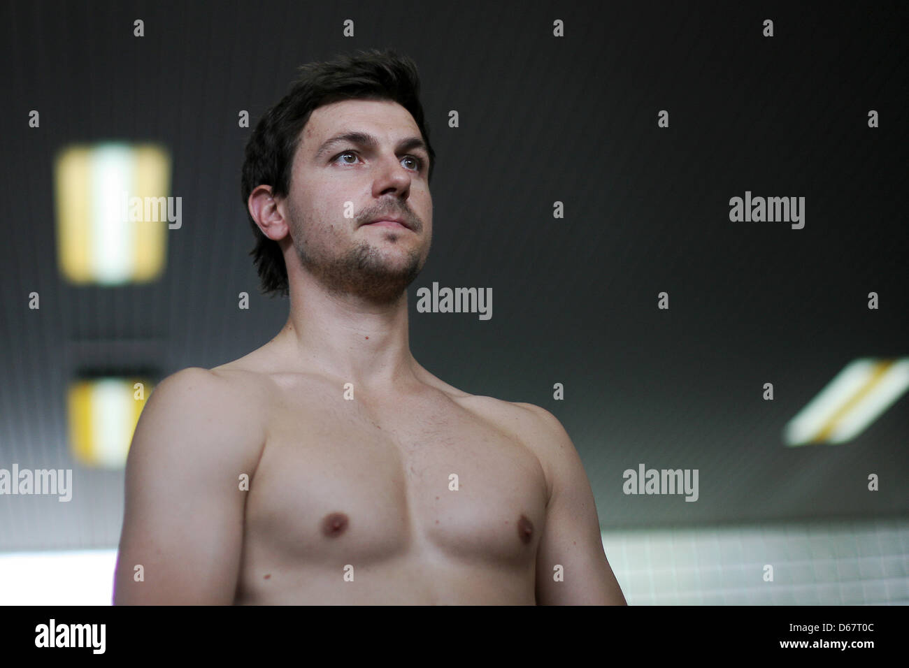 Table tennis player Timo Boll waits for a T-shirt of the Olympic ...