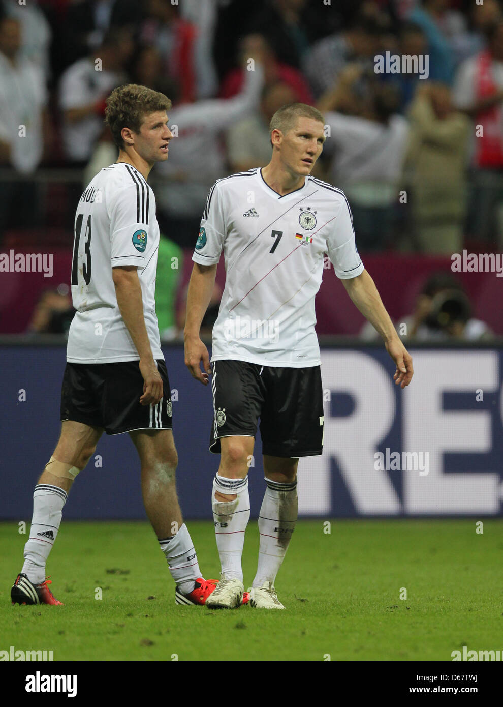 Germany's Bastian Schweinsteiger (R) and Thomas Mueller react after the ...