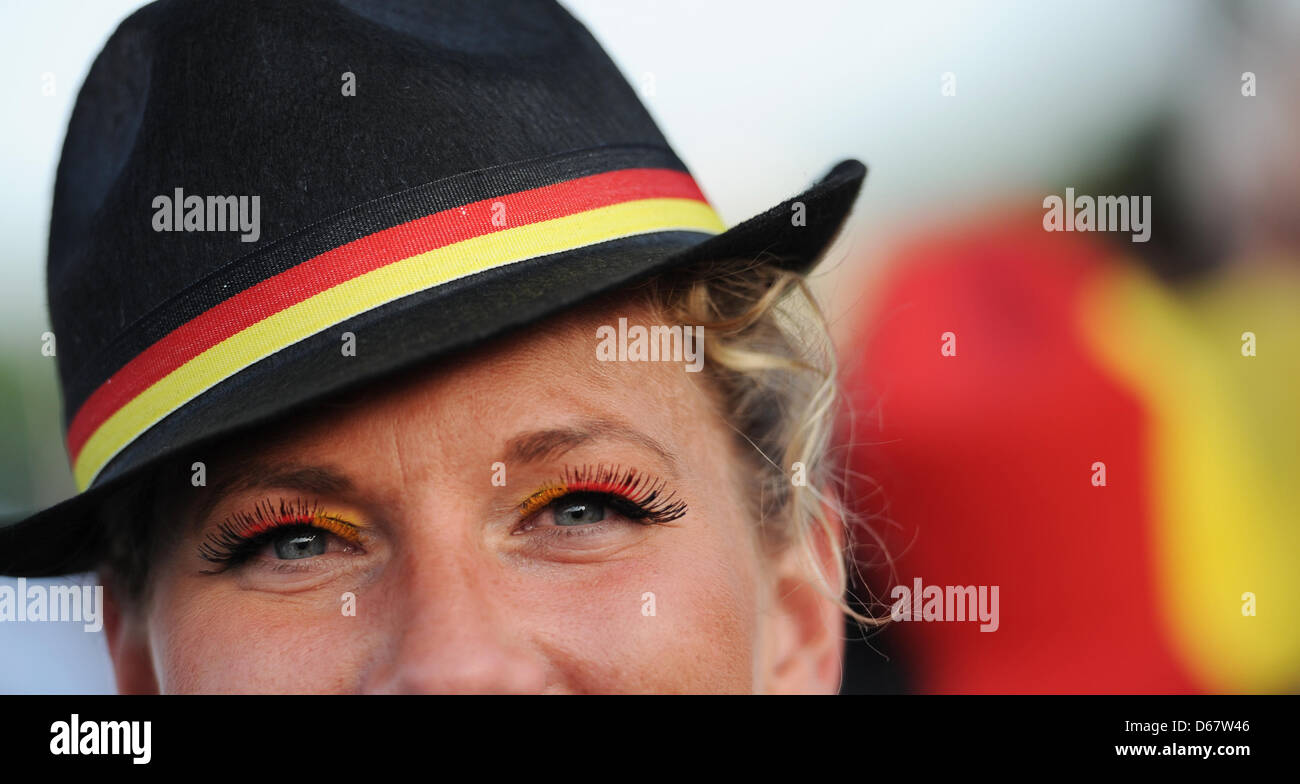 A female soccer fan wears a hat with the German flag during watching ...