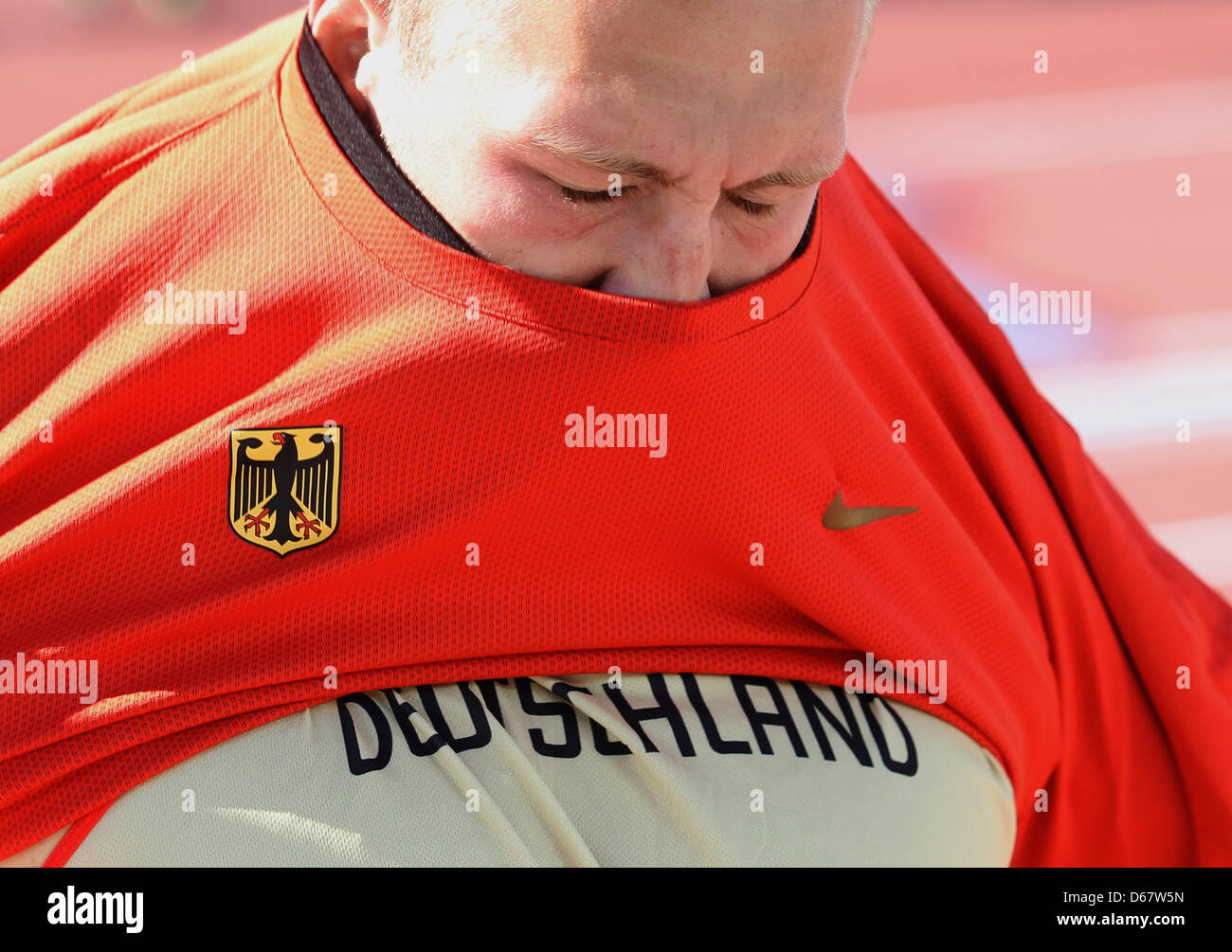 Robert Harting of Germany changes his jersey during the discus ...