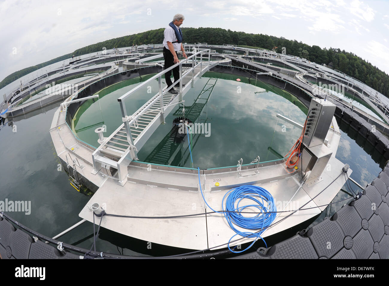 Dr Peter Casper walks across a bridge of the swimming sea laboratory in ...