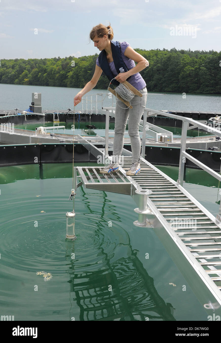 PhD student Jennifer Huepeden takes a water sample from the swimming ...