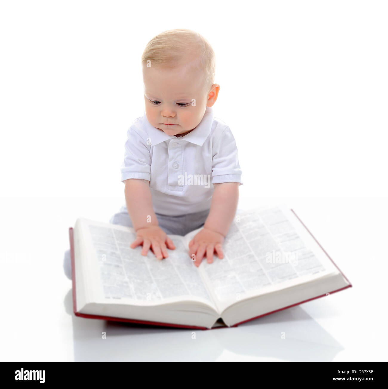 Little boy reads a big book Stock Photo - Alamy