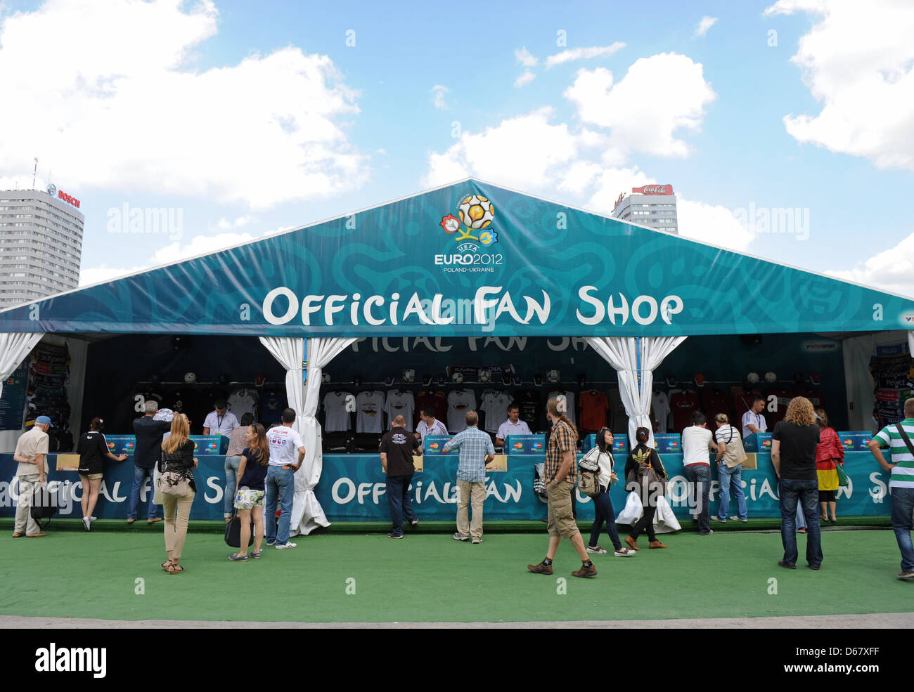 People stand in front of an official Uefa fan shop at the fan zone in ...